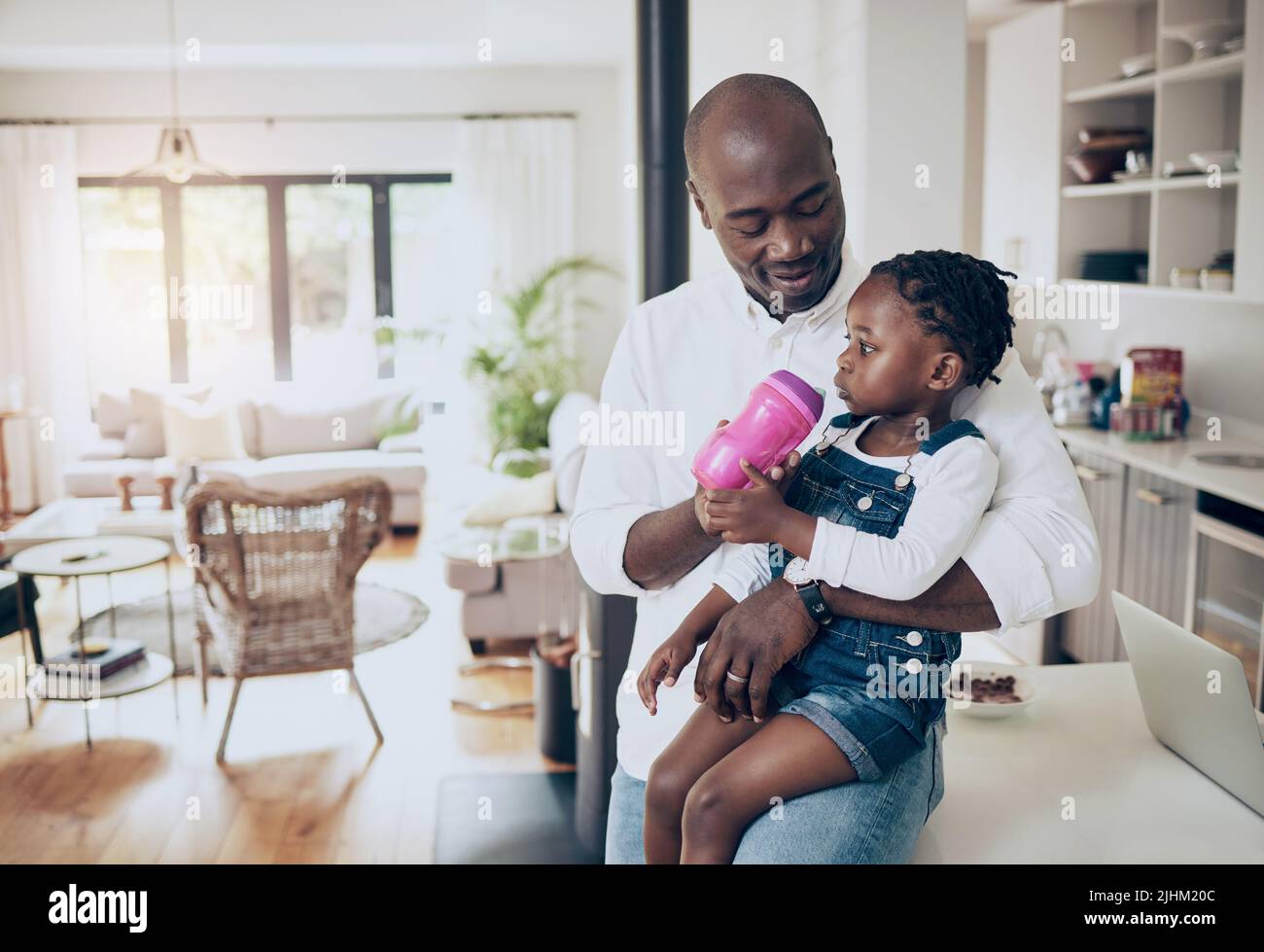 Fatherhood is a true blessing. a happy father feeding and spending time ...