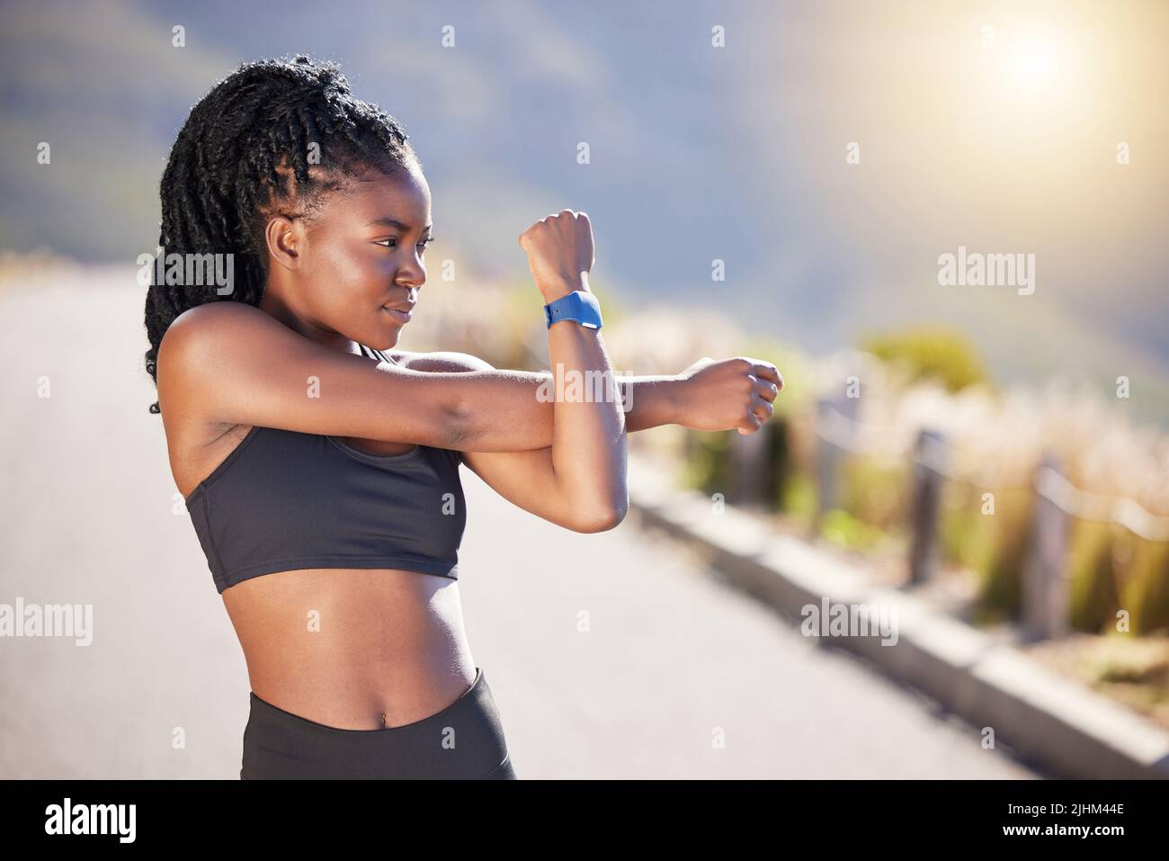 Active and fit young woman stretching her arms while exercising ...