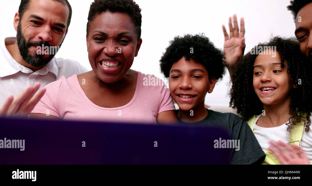 Happy family video conference on laptop webcam. interracial parents and ...