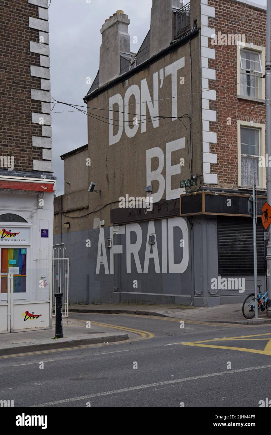 A business premises displaying pride flags & a large street art mural ...