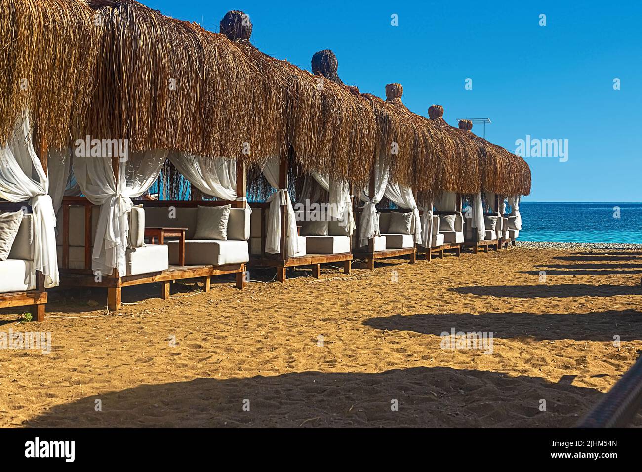 View of deck chairs and umbrellas on the sandy beach of Kemer, Turkey ...