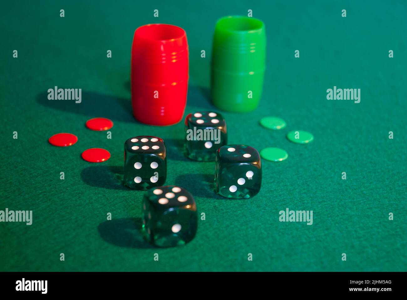 Four dice, two dice cups and six tockens Stock Photo - Alamy