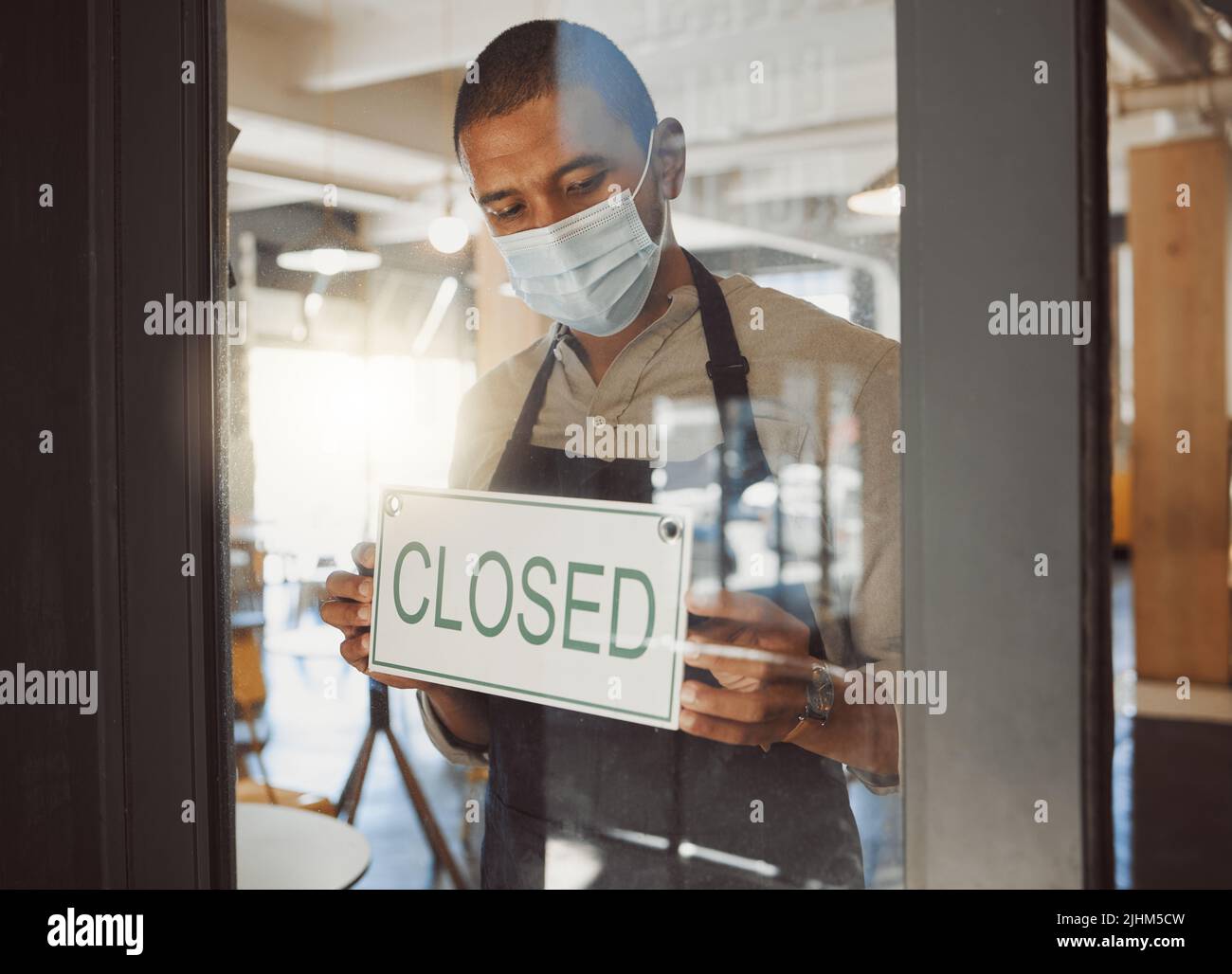 Business owner closing their shop in the pandemic. Boss hanging a ...