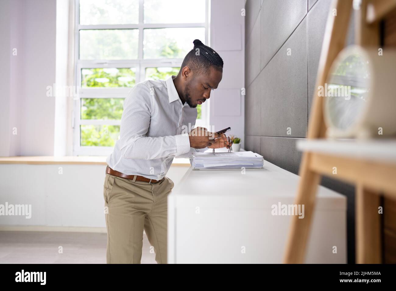 Employee Stealing Documents In Office Using Phone. Secret Theft Stock ...