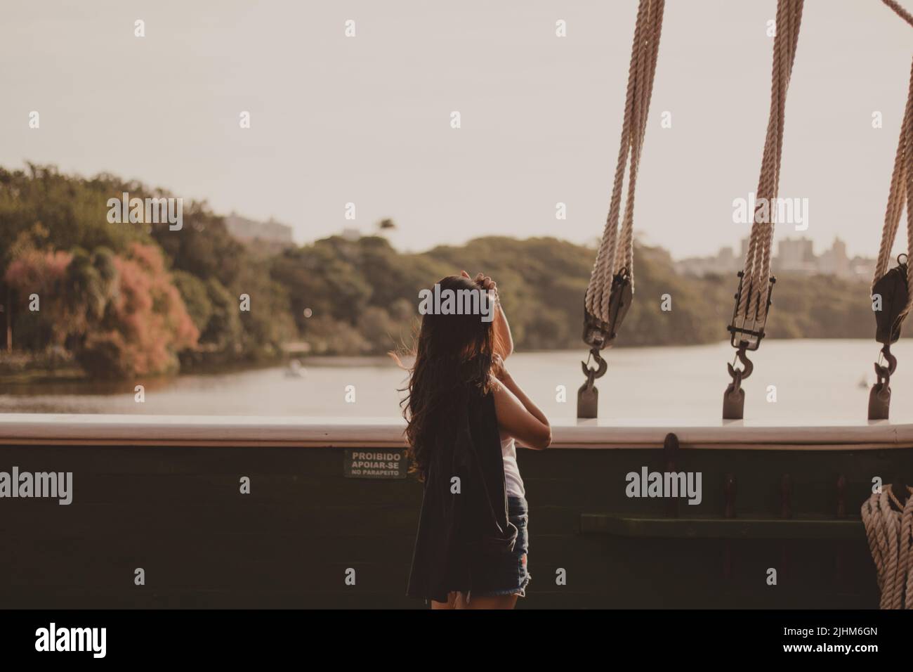 back side of a young woman on a boat looking at the sea Stock Photo - Alamy