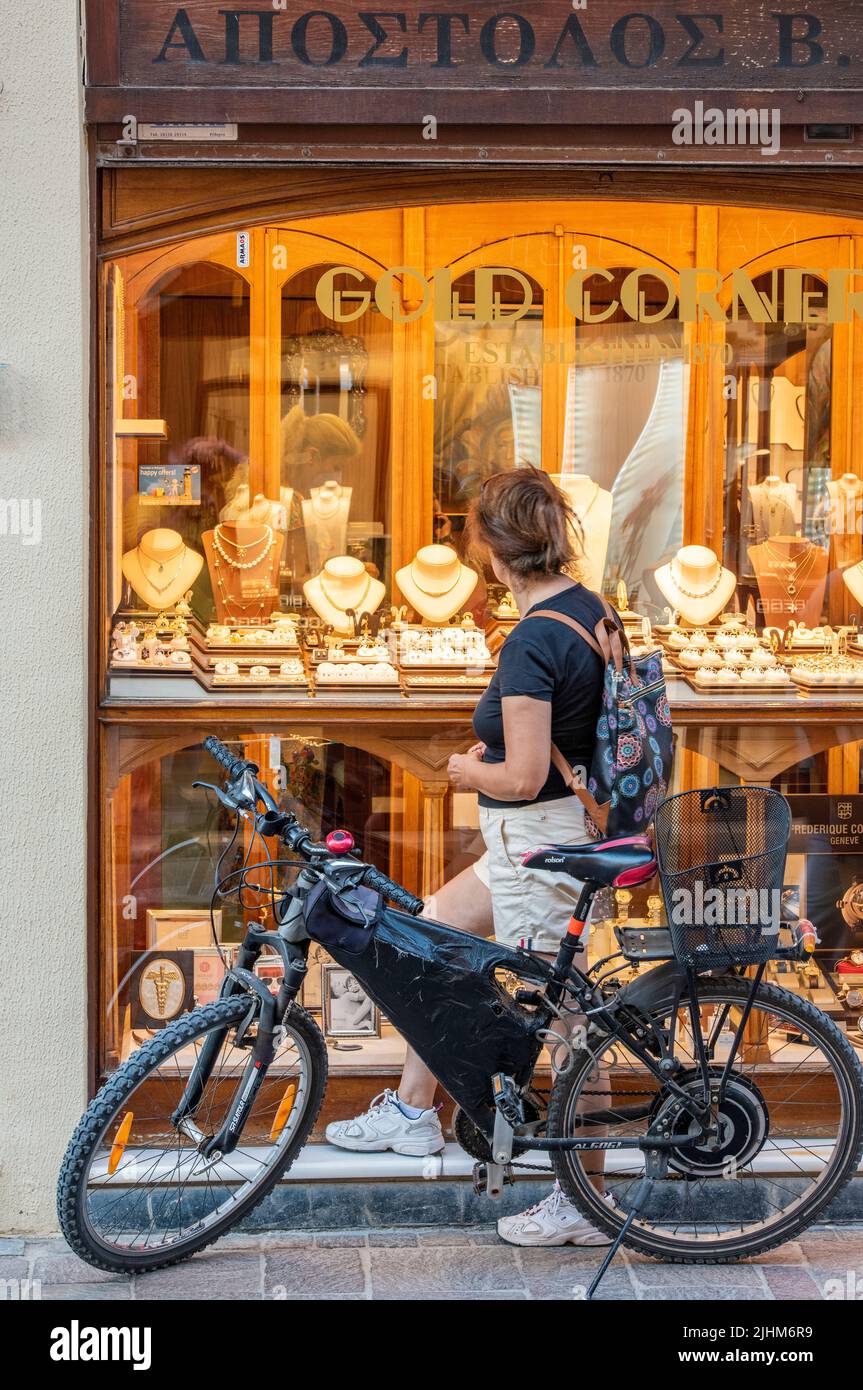 lady looking into the window of a jewellers shop, lady with bike ...