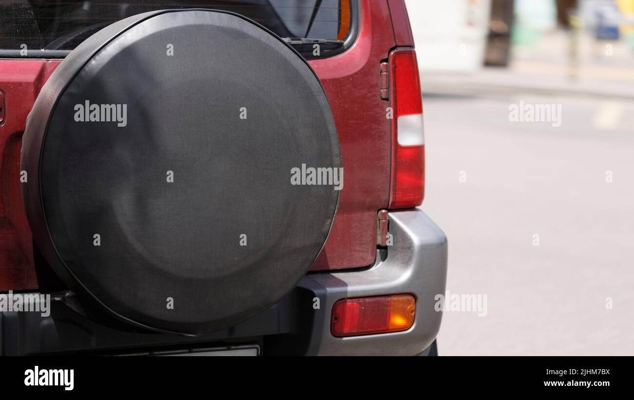 Spare wheel of a car in a case close-up, modern car rear view Stock ...