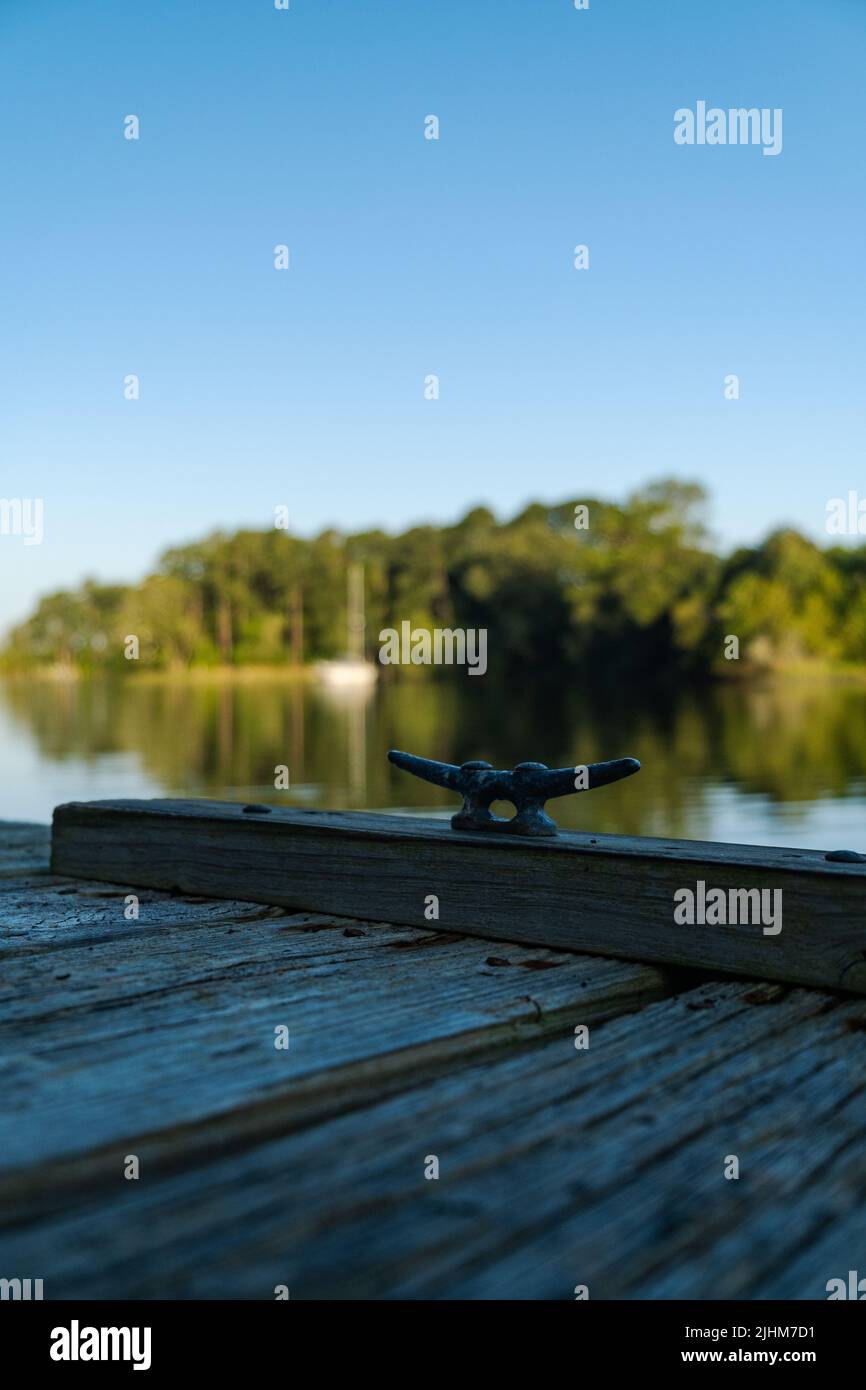 A wooden dock with a cleat on an inlet near the Atlantic Ocean ...