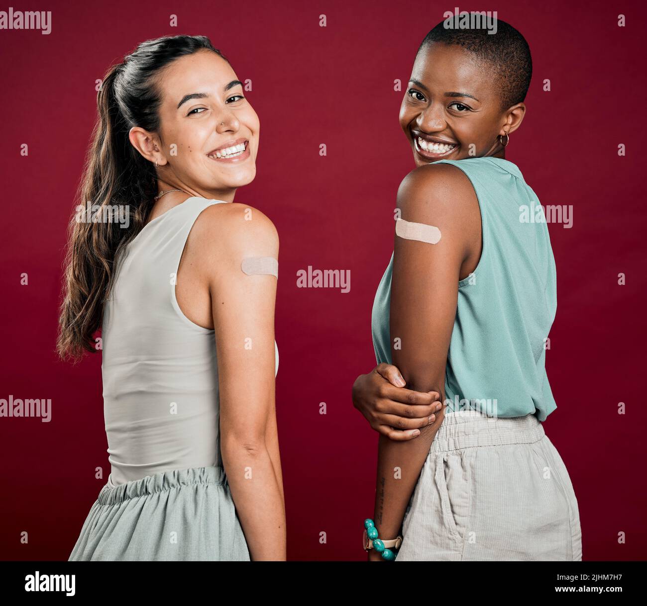 Covid vaccinated African american and mixed race women showing arm ...