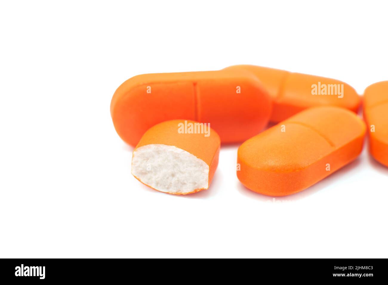 Medical pill of orange color on a white background. Medicines ...
