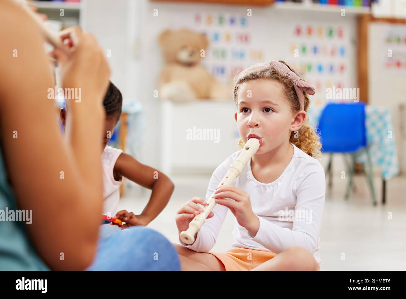 Music and children simply go together. a woman teaching her students ...