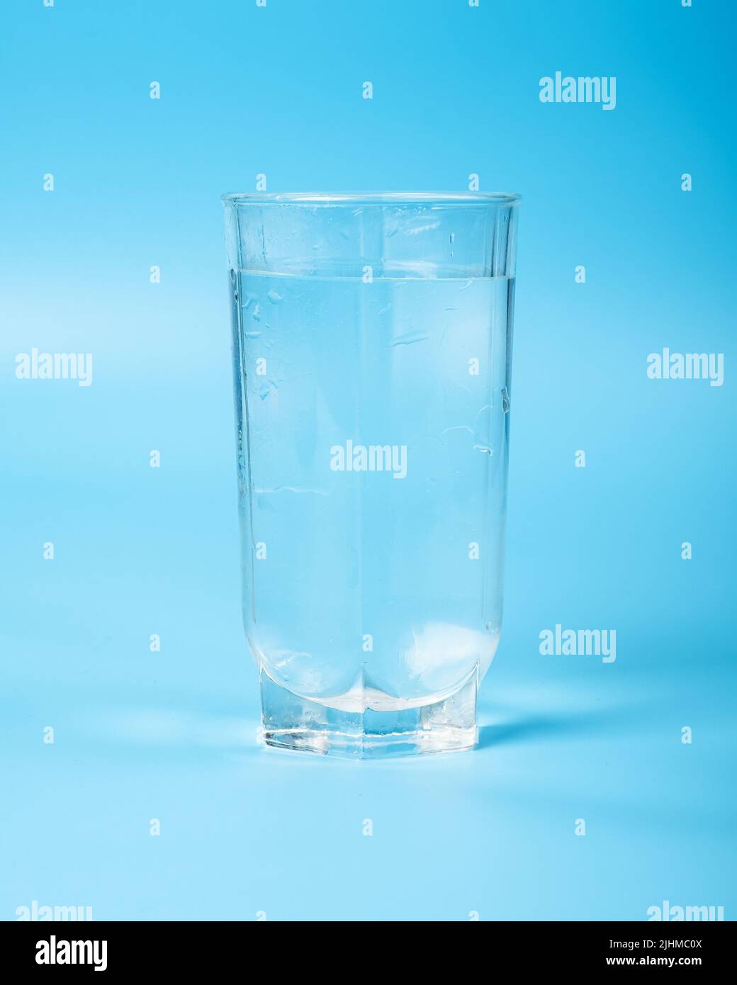 clean water in a glass beaker closeup on a blue background Stock Photo ...