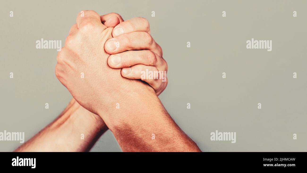Arms wrestling. Closep up. Friendly handshake, friends greeting ...
