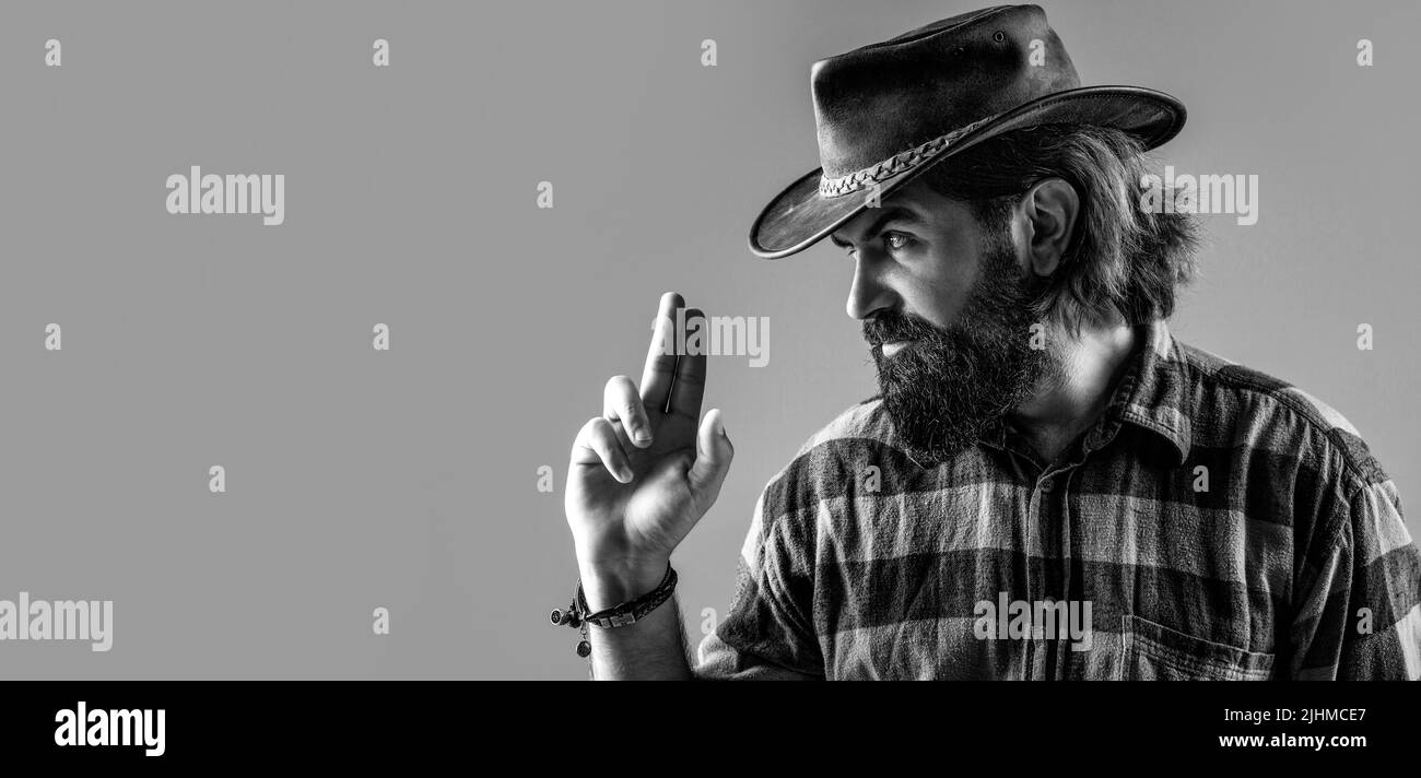 Portrait of man wearing cowboy hat, gun. Portrait of a cowboy. West ...