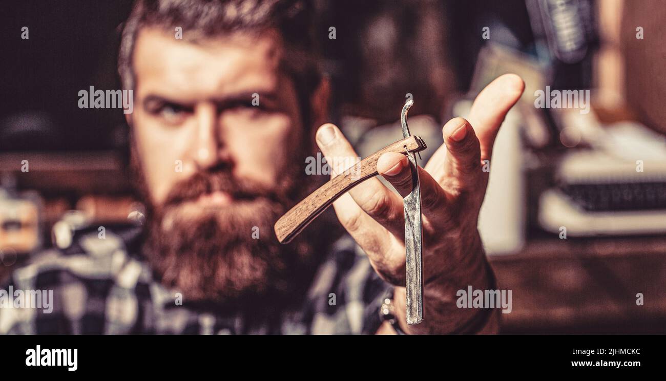 Portrait of brutal bearded man. Vintage straight razor. Mens haircut ...