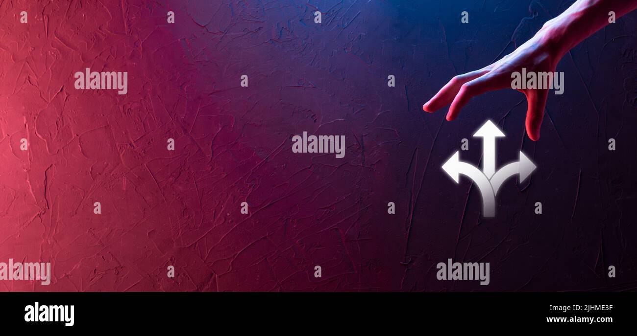 Businessman in a suit holds a sign showing three directions. in doubt ...