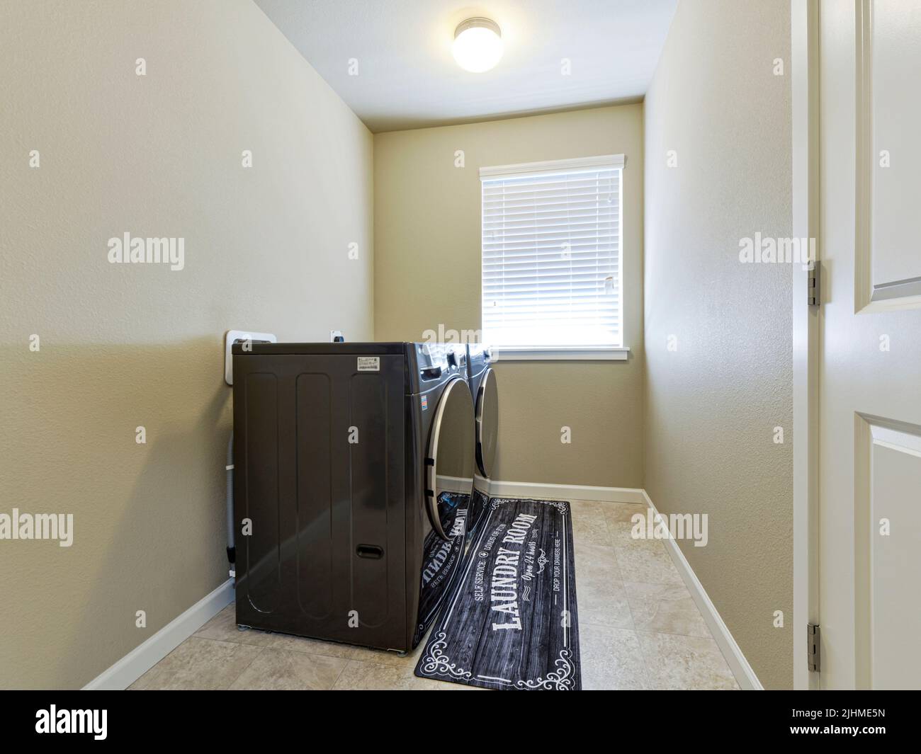 Modern residential laundry room interior Stock Photo - Alamy