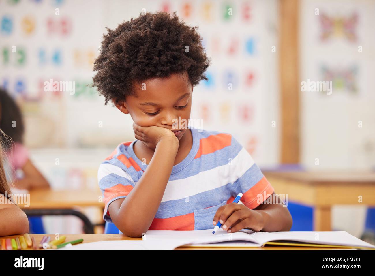 This is taking forever. a preschooler colouring in class Stock Photo ...