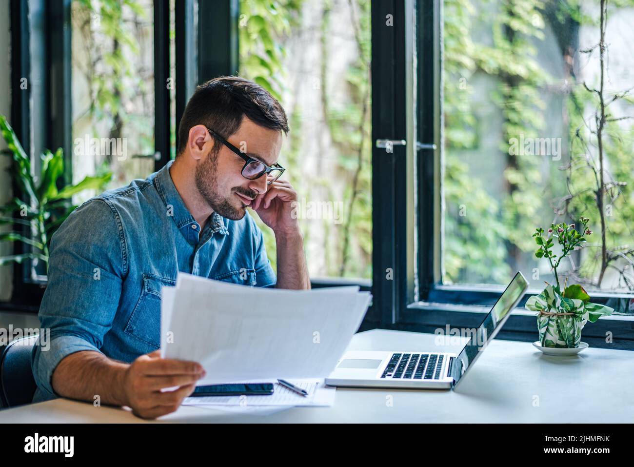 Male entrepreneur or businessman expert reading documents at office ...