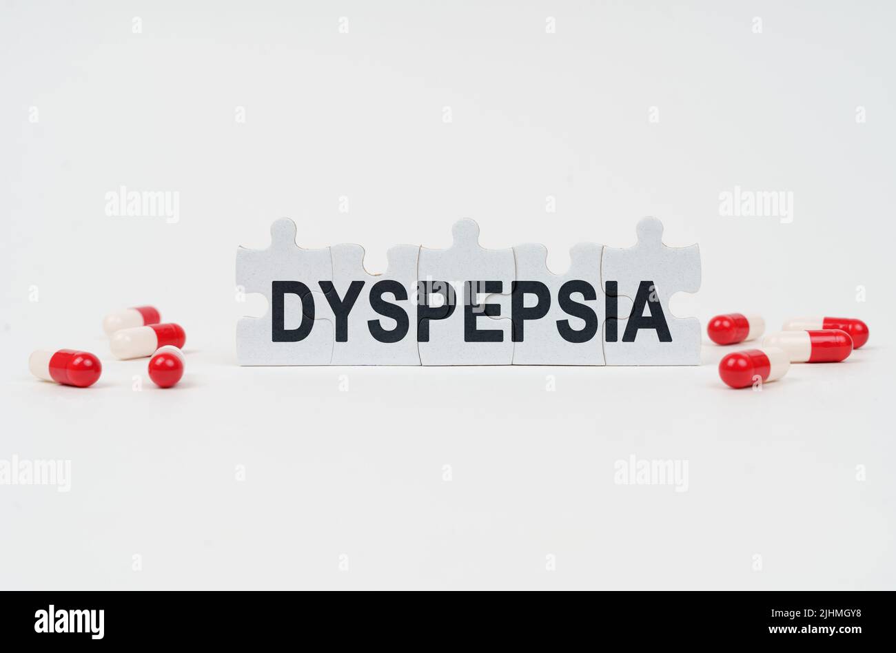 Medical concept. On a white surface are tablets and puzzles with the ...