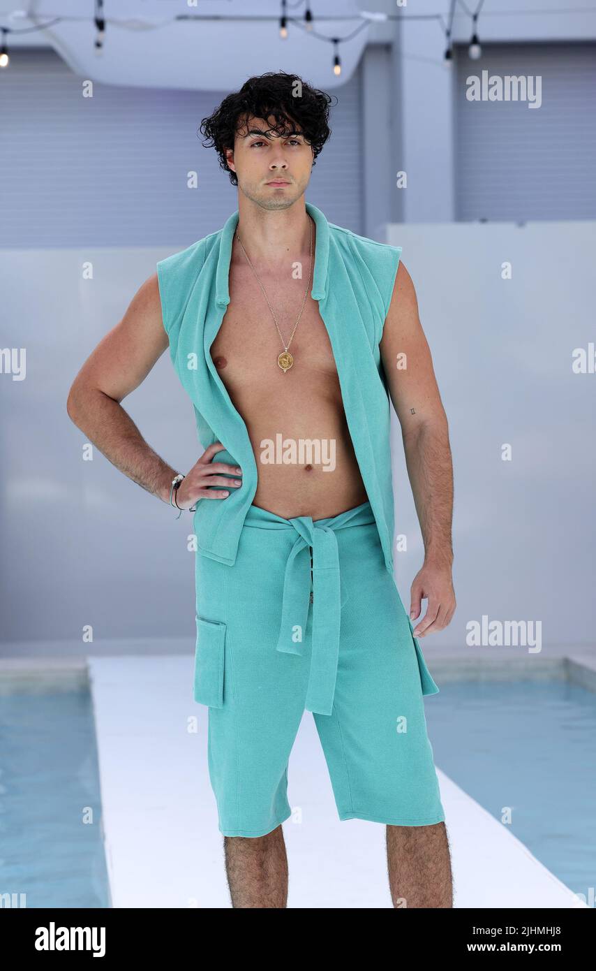 MIAMI BEACH, FLORIDA - JULY 18: A model walks the runway wearing ...