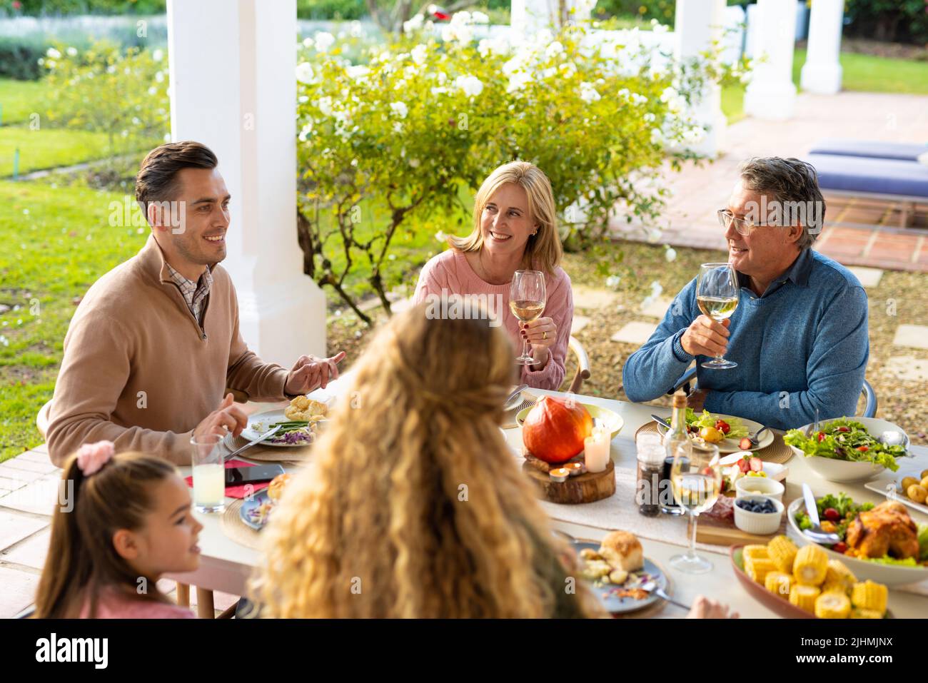 Image of multi generation caucasian family eating outdoor dinner Stock ...