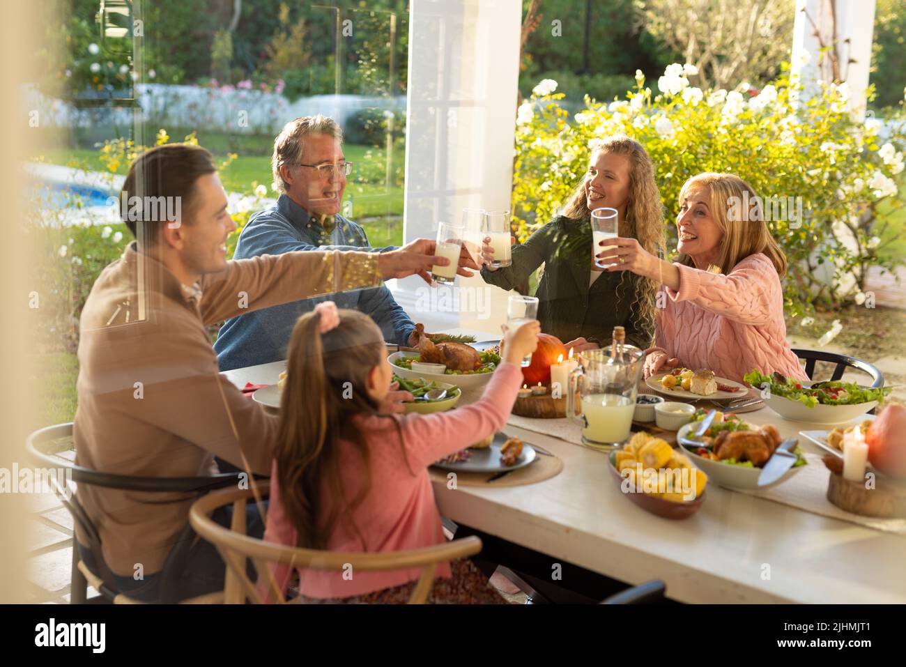 Image of multi generation caucasian family eating outdoor dinner Stock ...