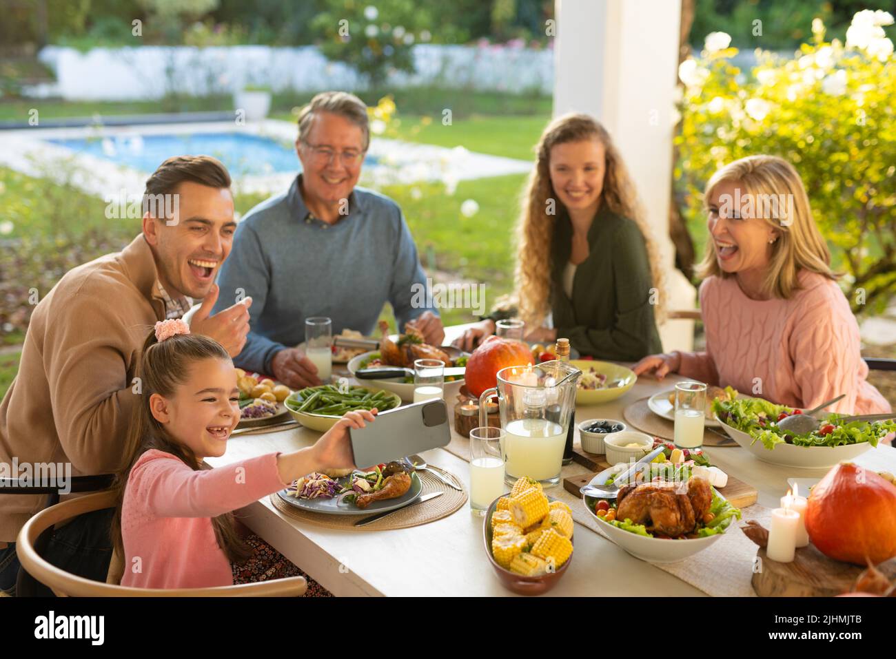 Image of multi generation caucasian family eating outdoor dinner Stock ...