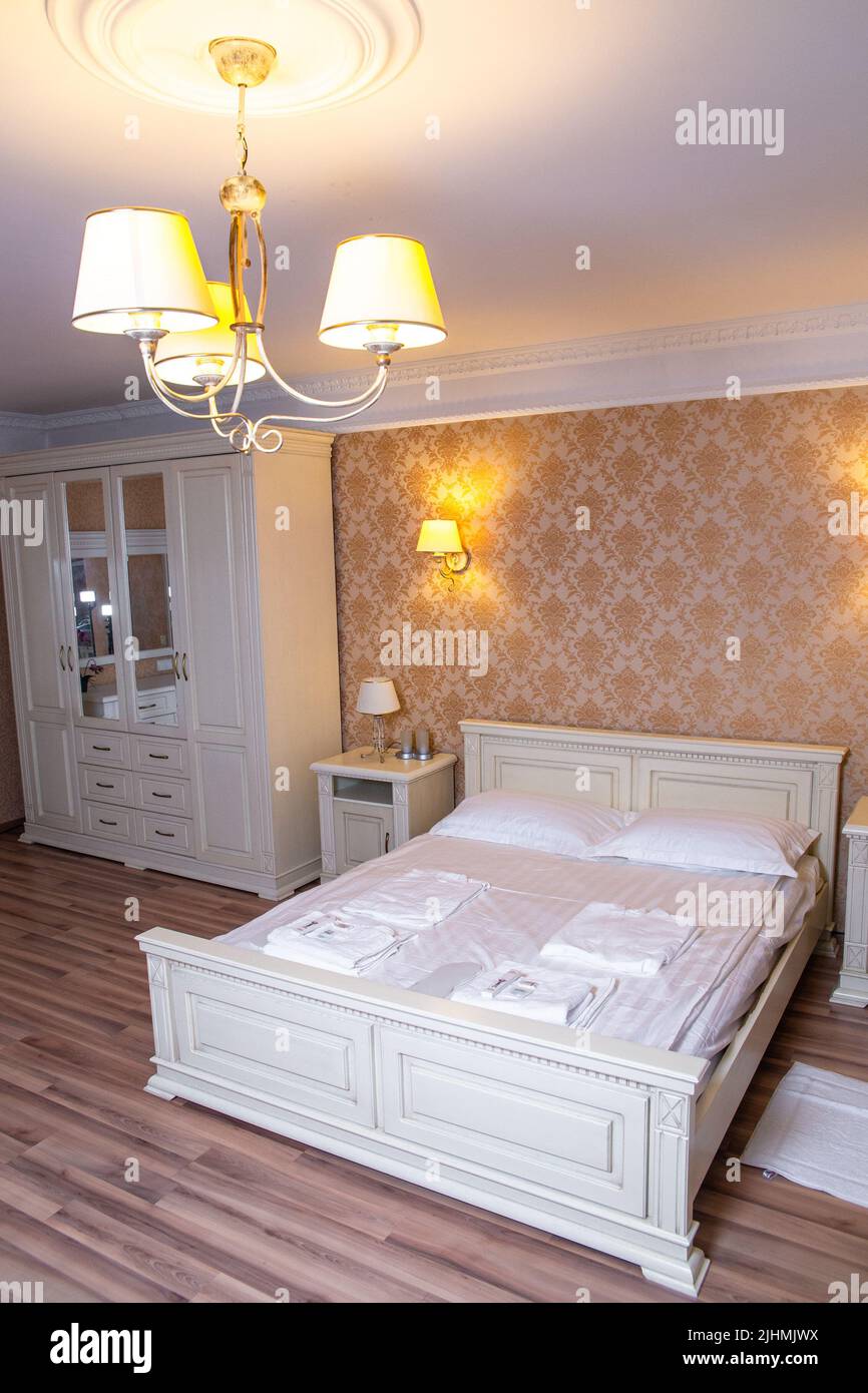 luxury room with vintage wallpaper and a double bed. fresh bed linen ...