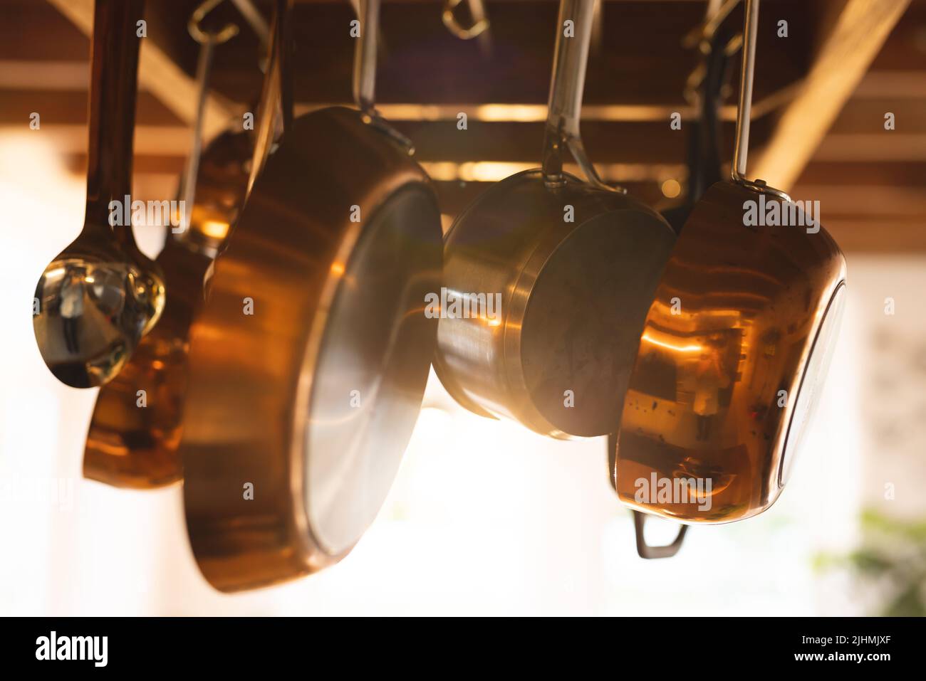 Image of copper pots and plates hanging in kitchen Stock Photo - Alamy