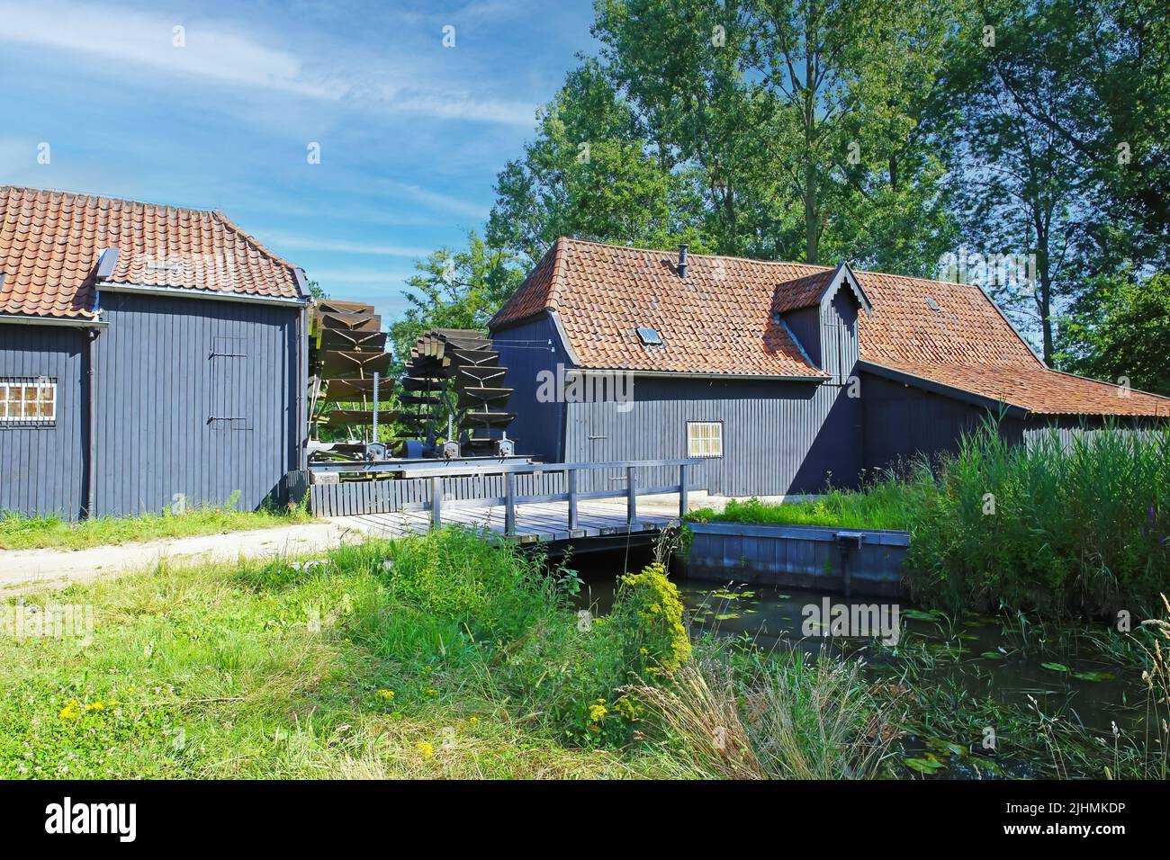 Two scenic idyllic ancient wooden gray dutch country grist and oil ...