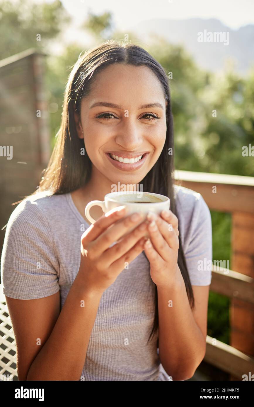 Starting the day off right with coffee. an attractive young woman ...