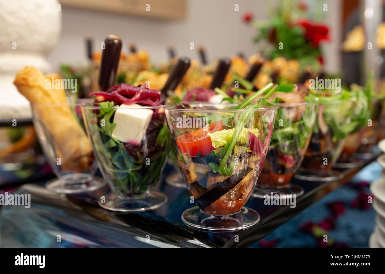 salads and snacks in plastic cups on the buffet Stock Photo - Alamy