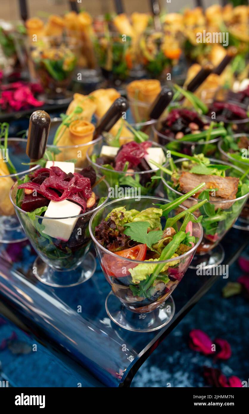 salads and snacks in plastic cups on the buffet Stock Photo - Alamy