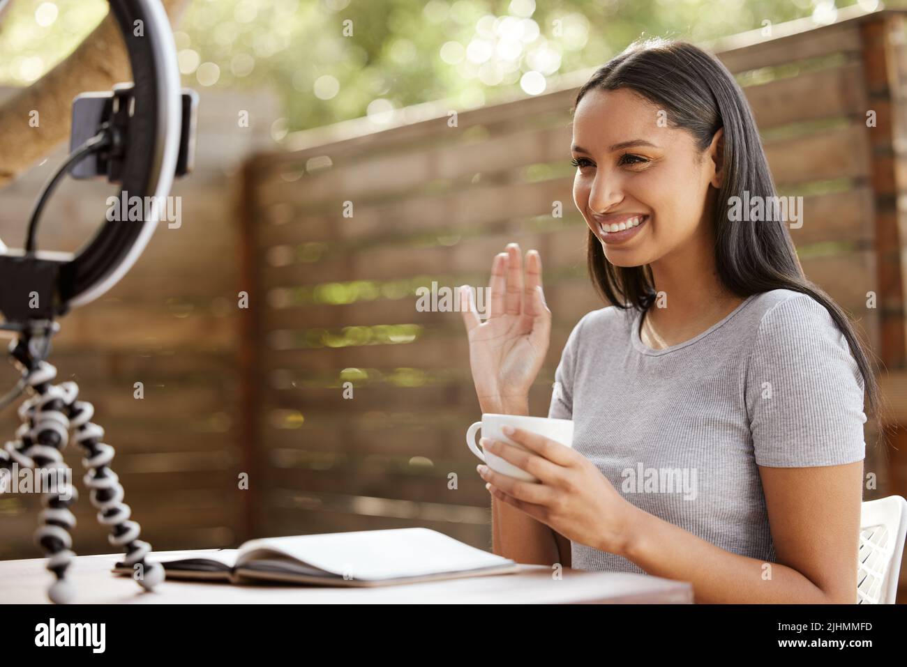 Hows everyone doing. an attractive young woman sitting alone outside ...