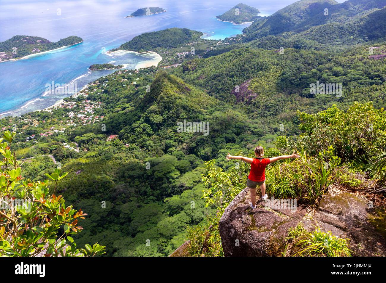 Young female traveler standing at the edge of the cliff at Morne Blanc ...