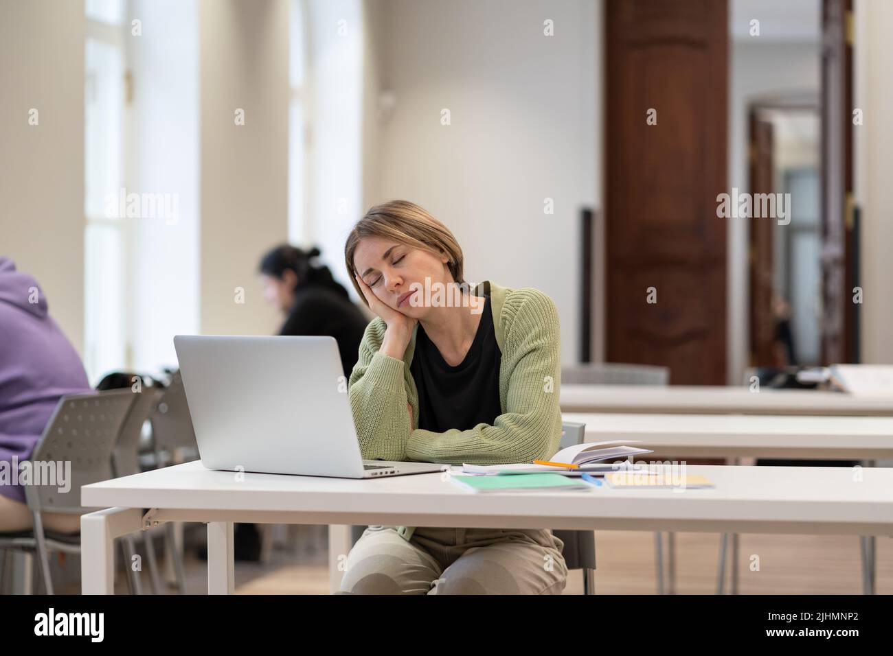 Sleepy bored middle-aged woman mature student falling asleep during boring online class Stock ...