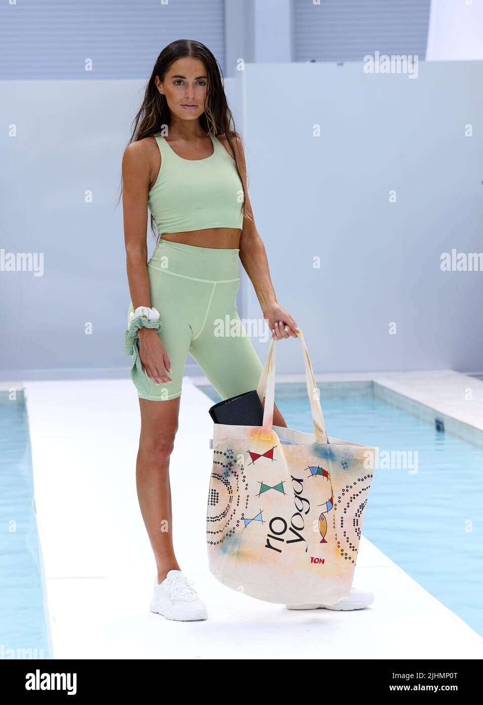MIAMI BEACH, FLORIDA - JULY 18: A model walks the runway wearing Rio Yoga during Flying Solo ...