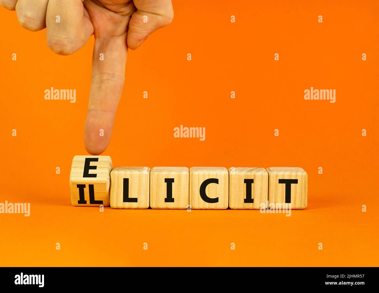 Illicit or elicit symbol. Businessman turns wooden cubes and changes ...
