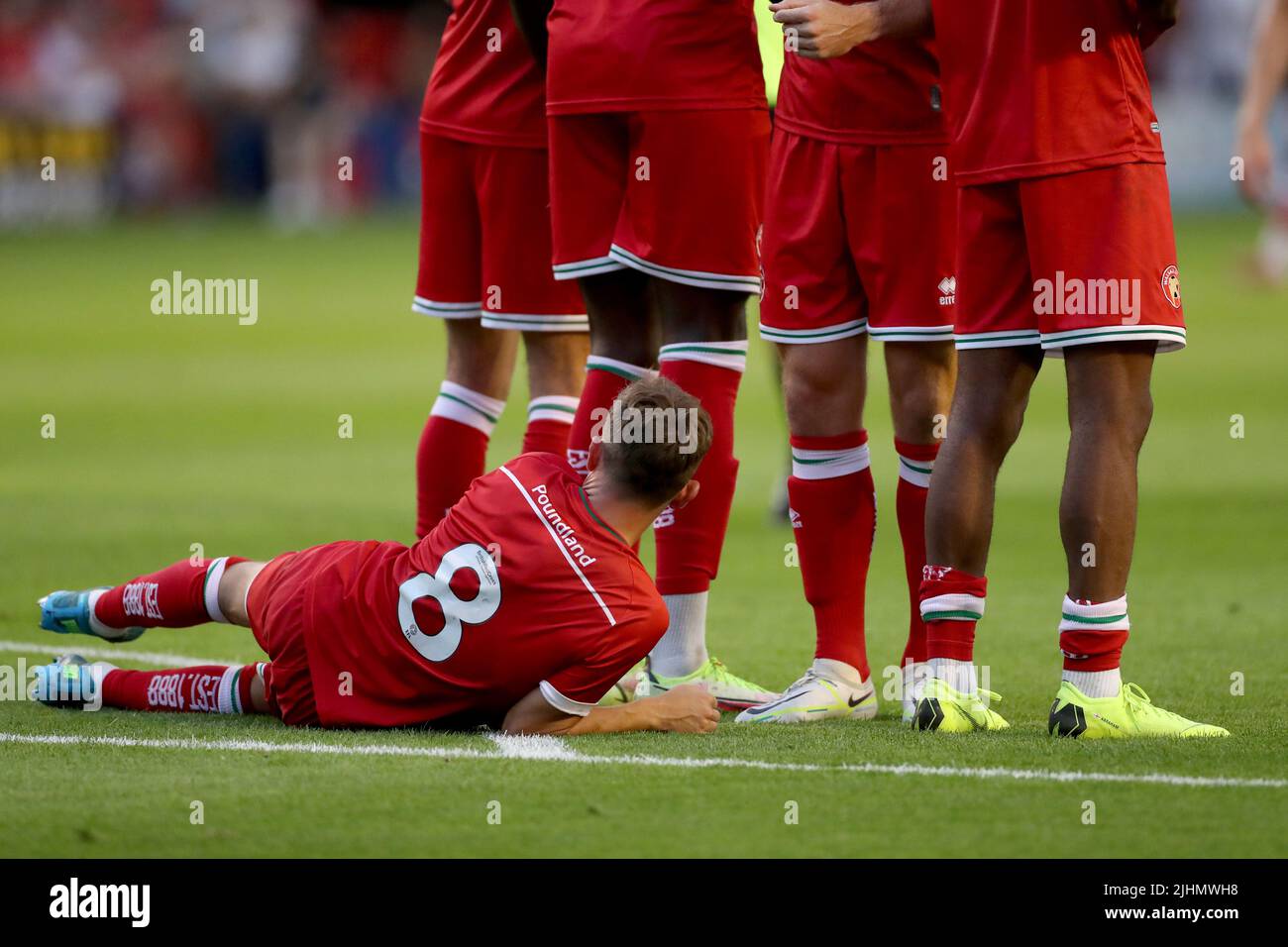 Walsall’s Liam Kinsella lies down under the wall during the pre-season ...