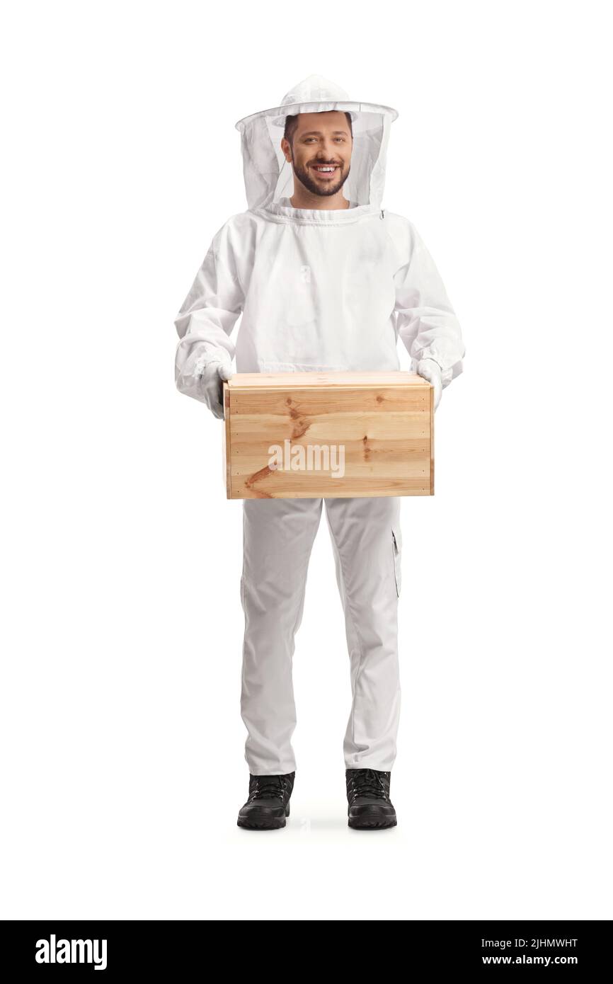 Full length portrait of a young male bee keeper in a uniform holding a ...