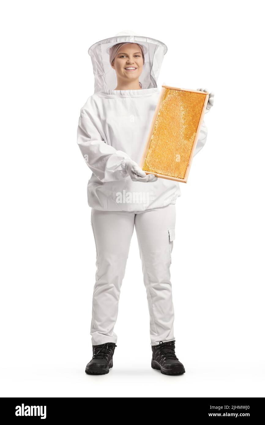 Full length portrait of a young female bee keeper in a uniform holding ...