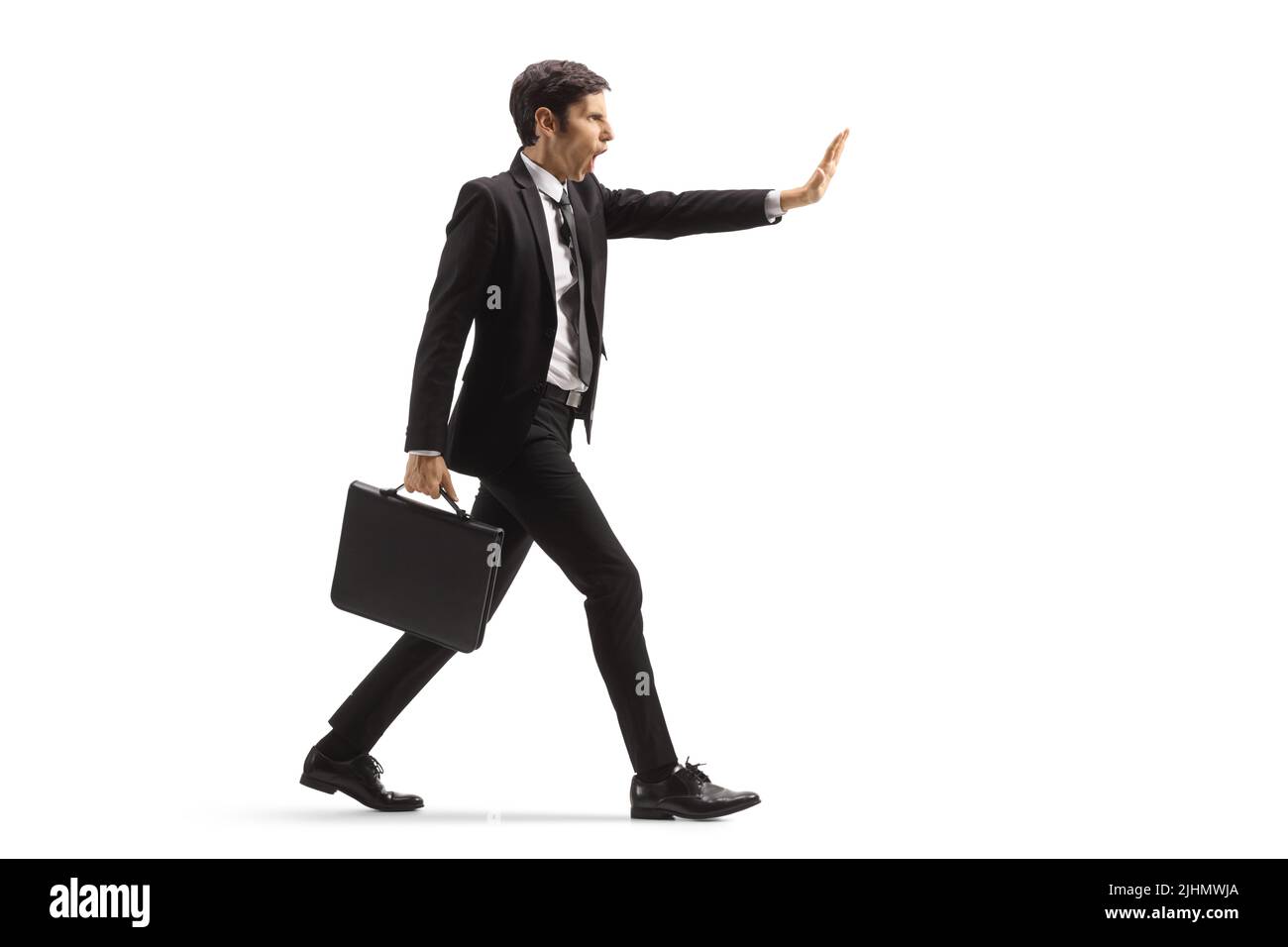 Full length profile shot of an angry businessman walking and gesturing ...