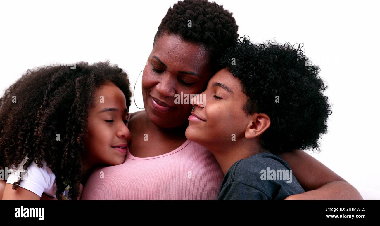 Loving mother and kids hug. Mom embracing children. African ethnicity ...