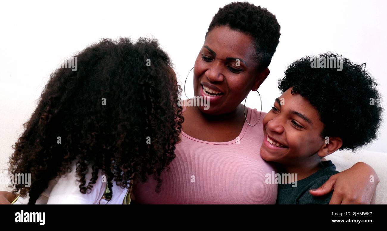 Loving mother and kids hug. Mom embracing children. African ethnicity ...