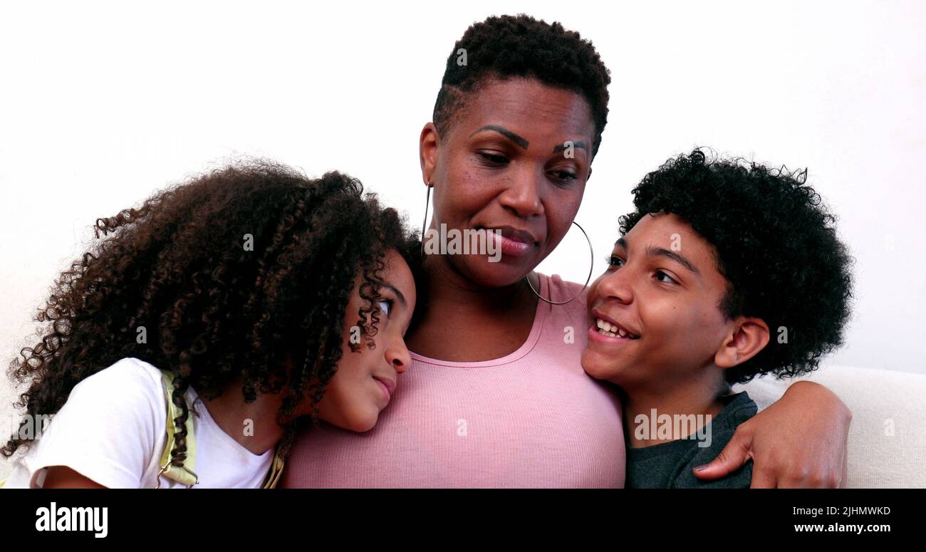 Loving mother and kids hug. Mom embracing children. African ethnicity ...