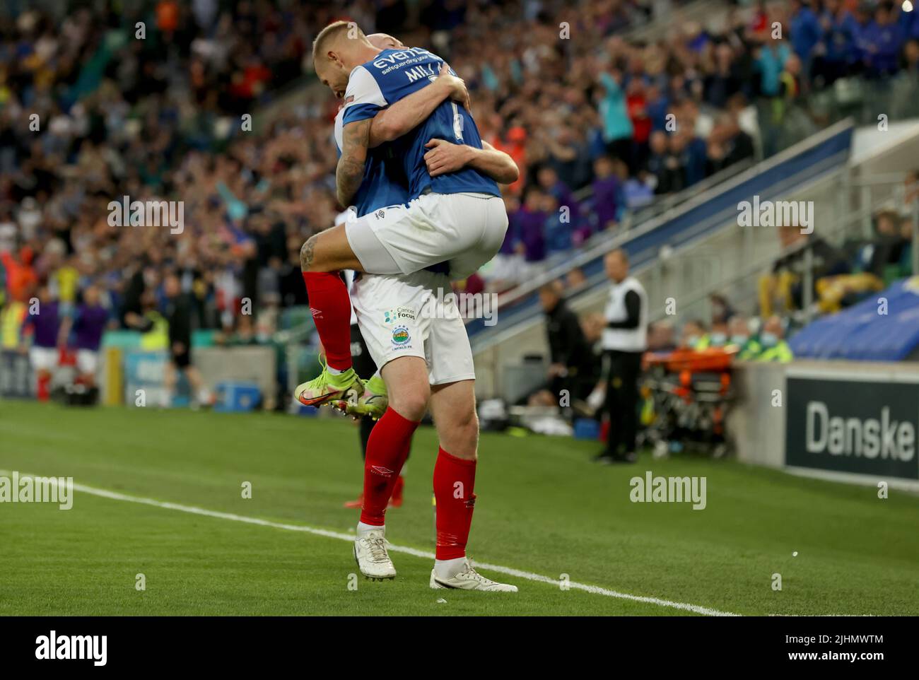 Linfield’s Kirk Millar celebrates with teammates after scoring during ...