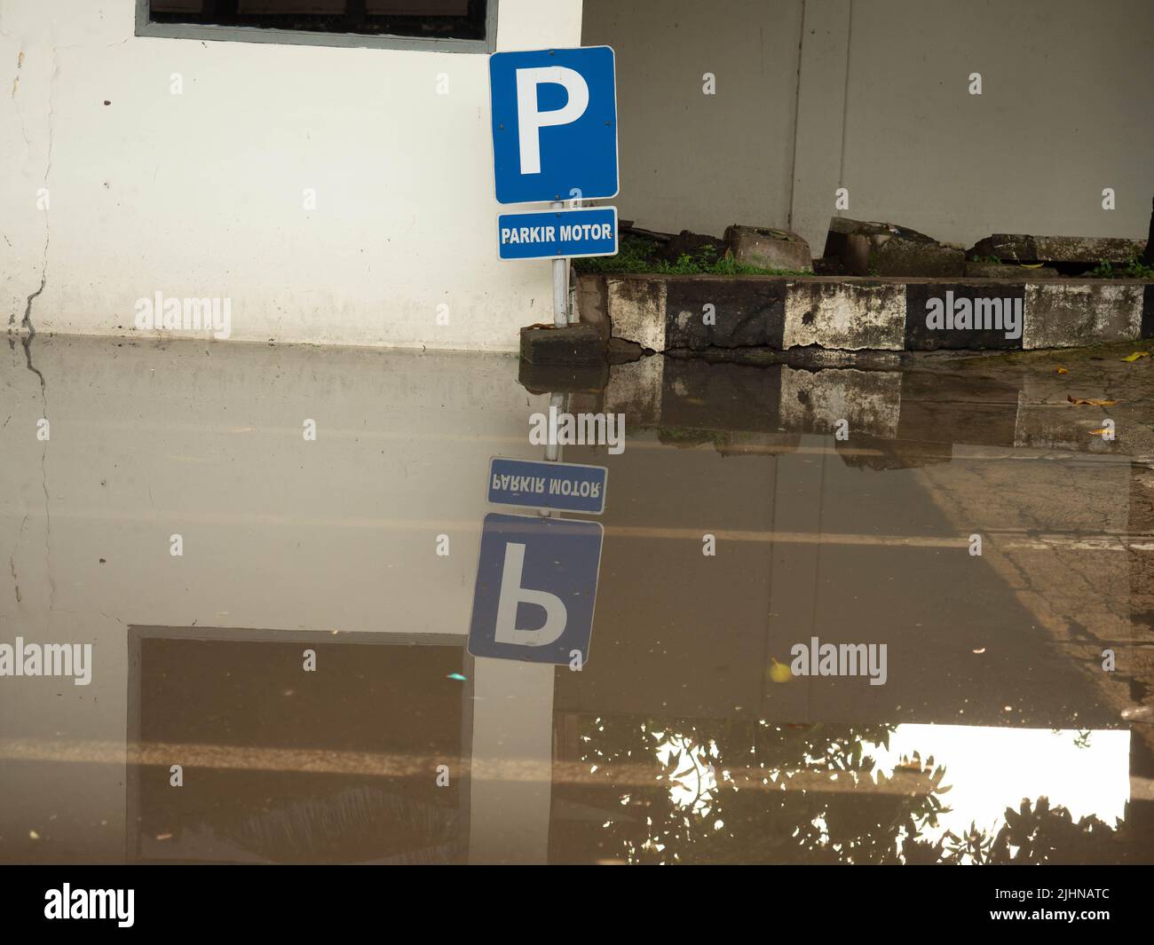 Water puddle formed after hard rain at the parking lot Stock Photo - Alamy