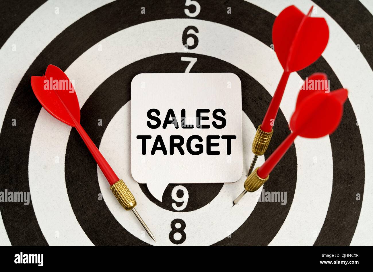 Business and economy concept. There is a sign on the target that says ...