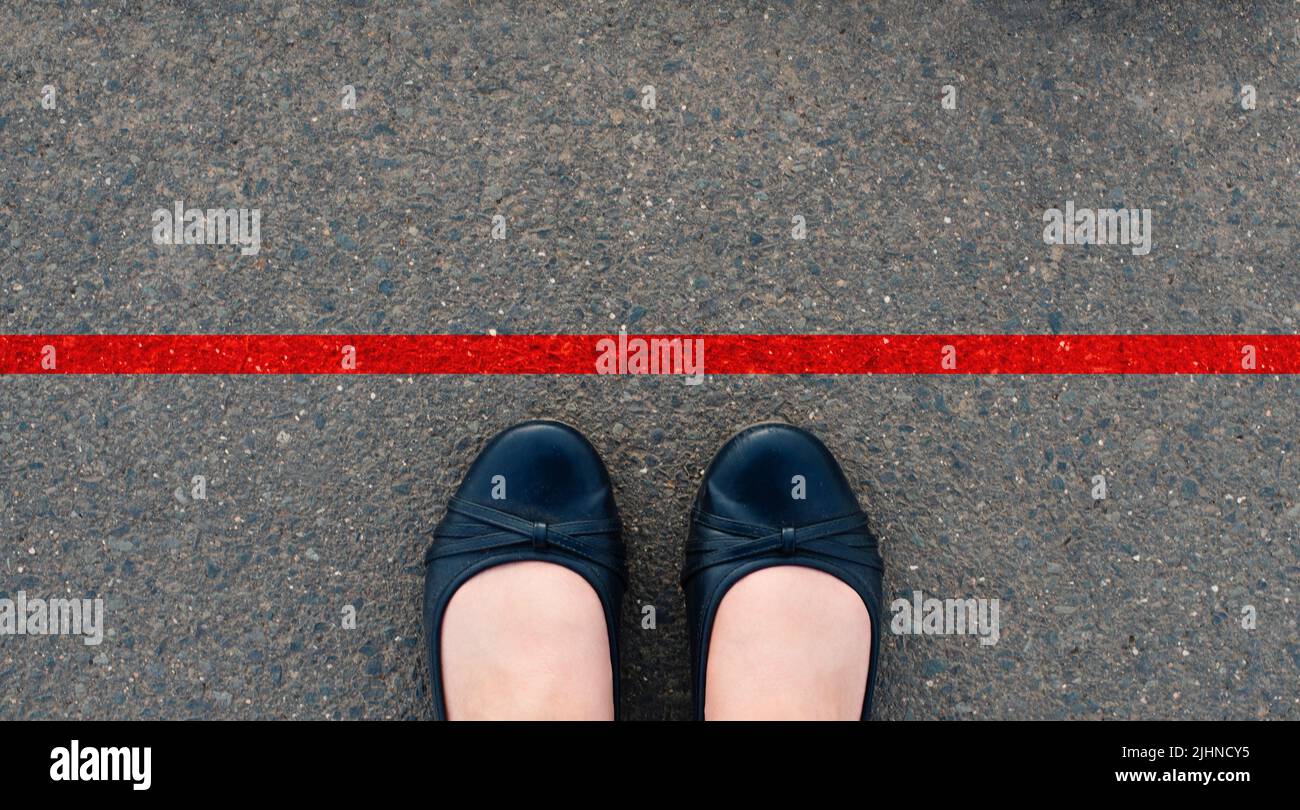 Red line on the road, someone is standing in front of the stop, having ...